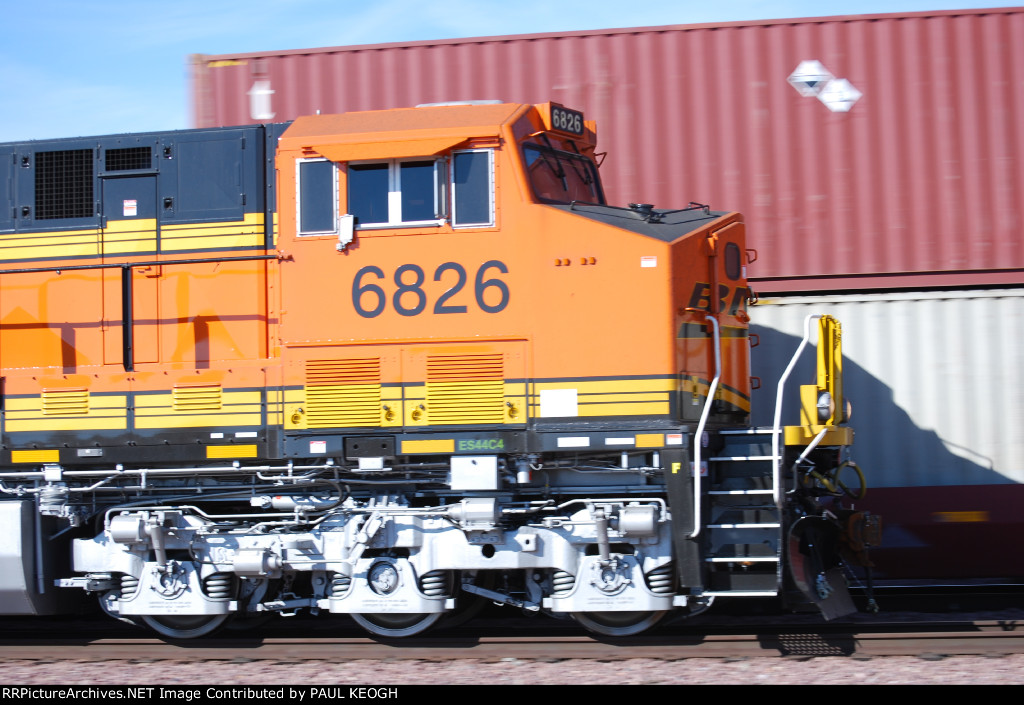 BNSF 6826 cab shot as sie passes a westbound Z as she enters the BNSF Barstow yard going east.
